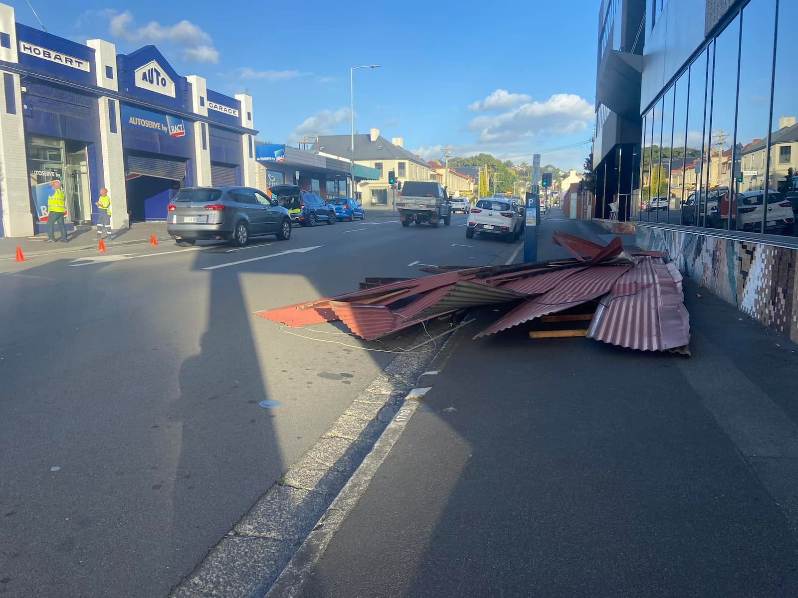 Strong winds blow roof off Hobart business, Harrington Street blocked ...