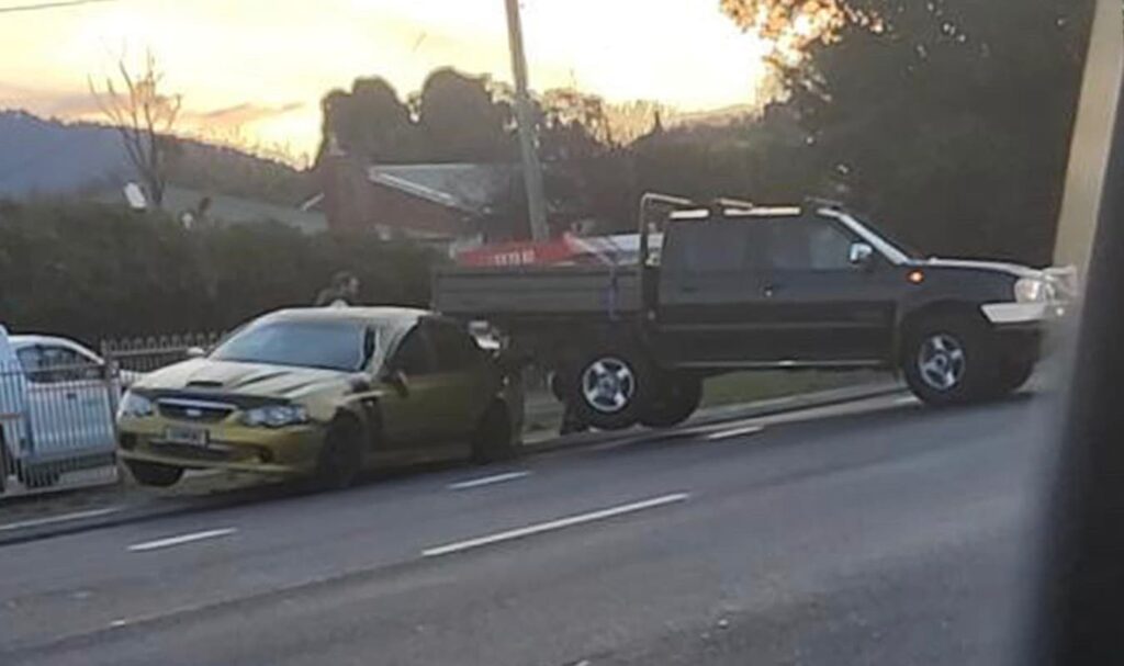 Ute crashes on top of small car in peak-hour on Hobart’s Brooker ...